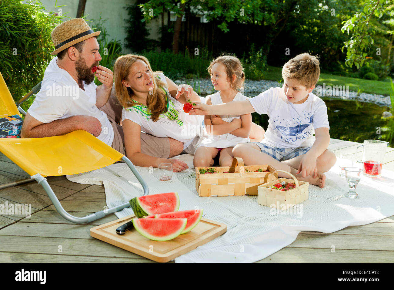 Family with two children having a picnic by the pond, Munich, Bavaria ...