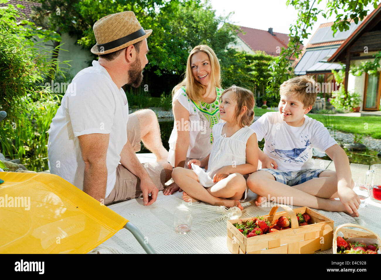 Family with two children having a picnic by the pond, Munich, Bavaria ...