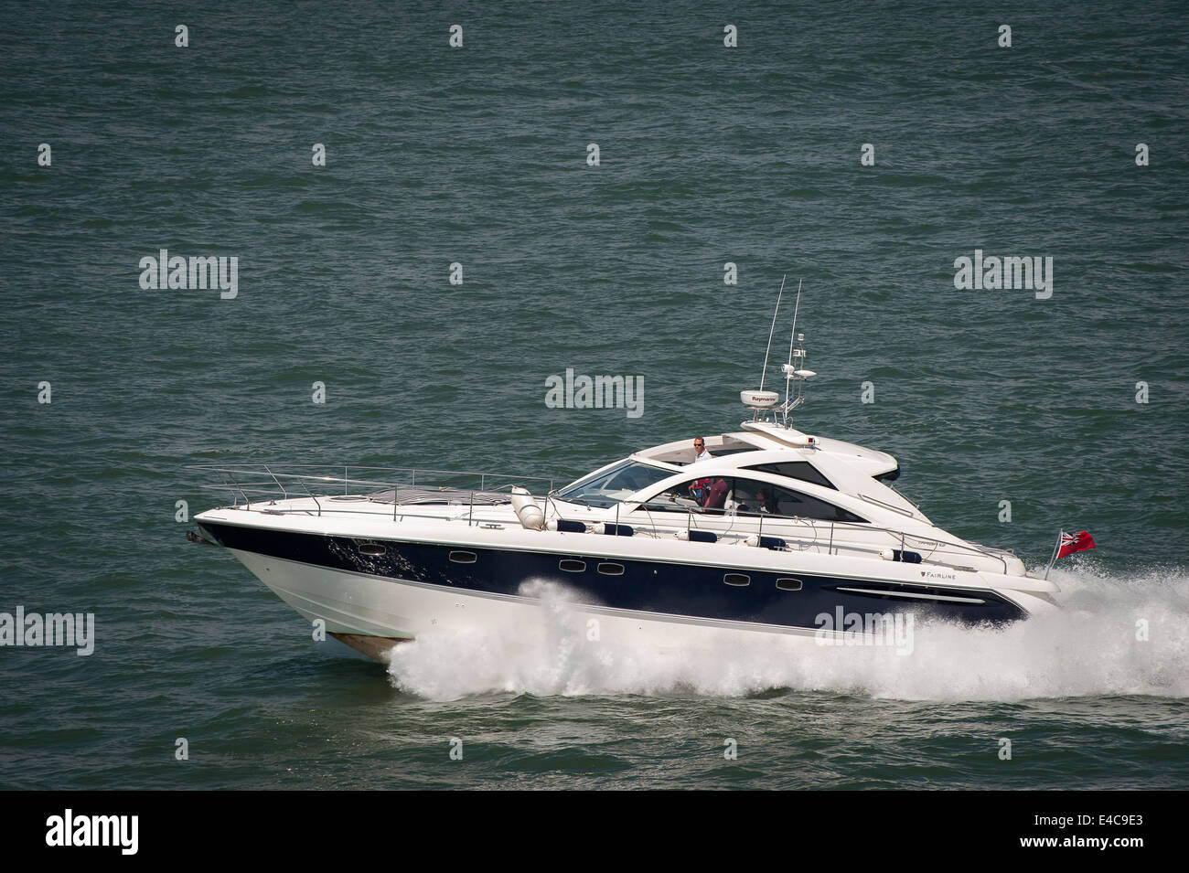 Boat speeding through the water just off the coast of the Isle of Wight ...