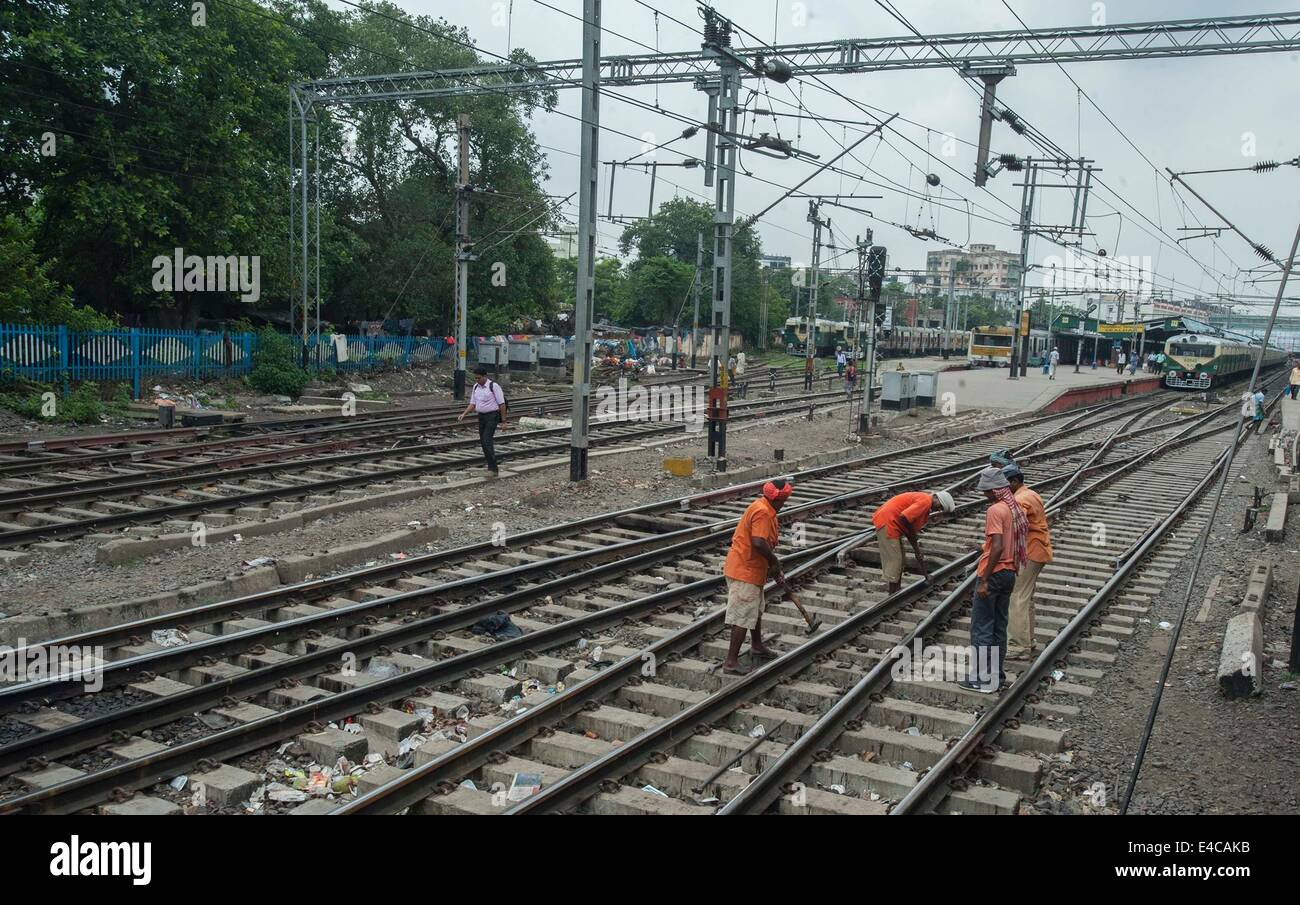 Calcutta, India. 8th July, 2014. Indian railway employees work on the ...