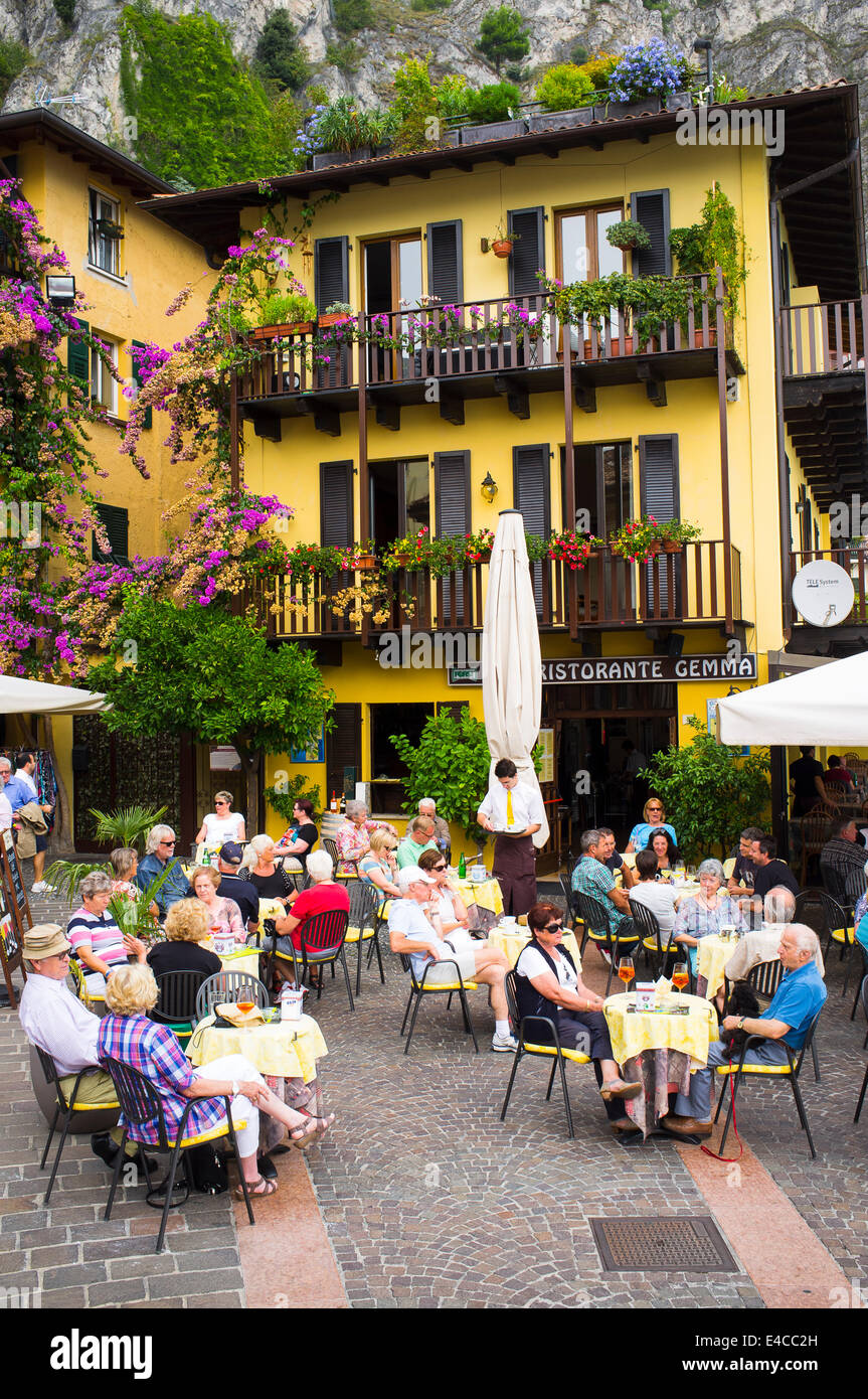Holidaymakers dining al fresco outside a restaurant in the picturesque ...