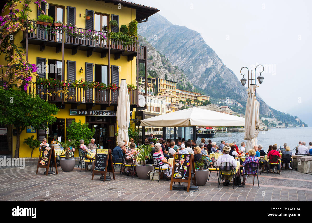 Holidaymakers dining al fresco outside a restaurant in the picturesque ...