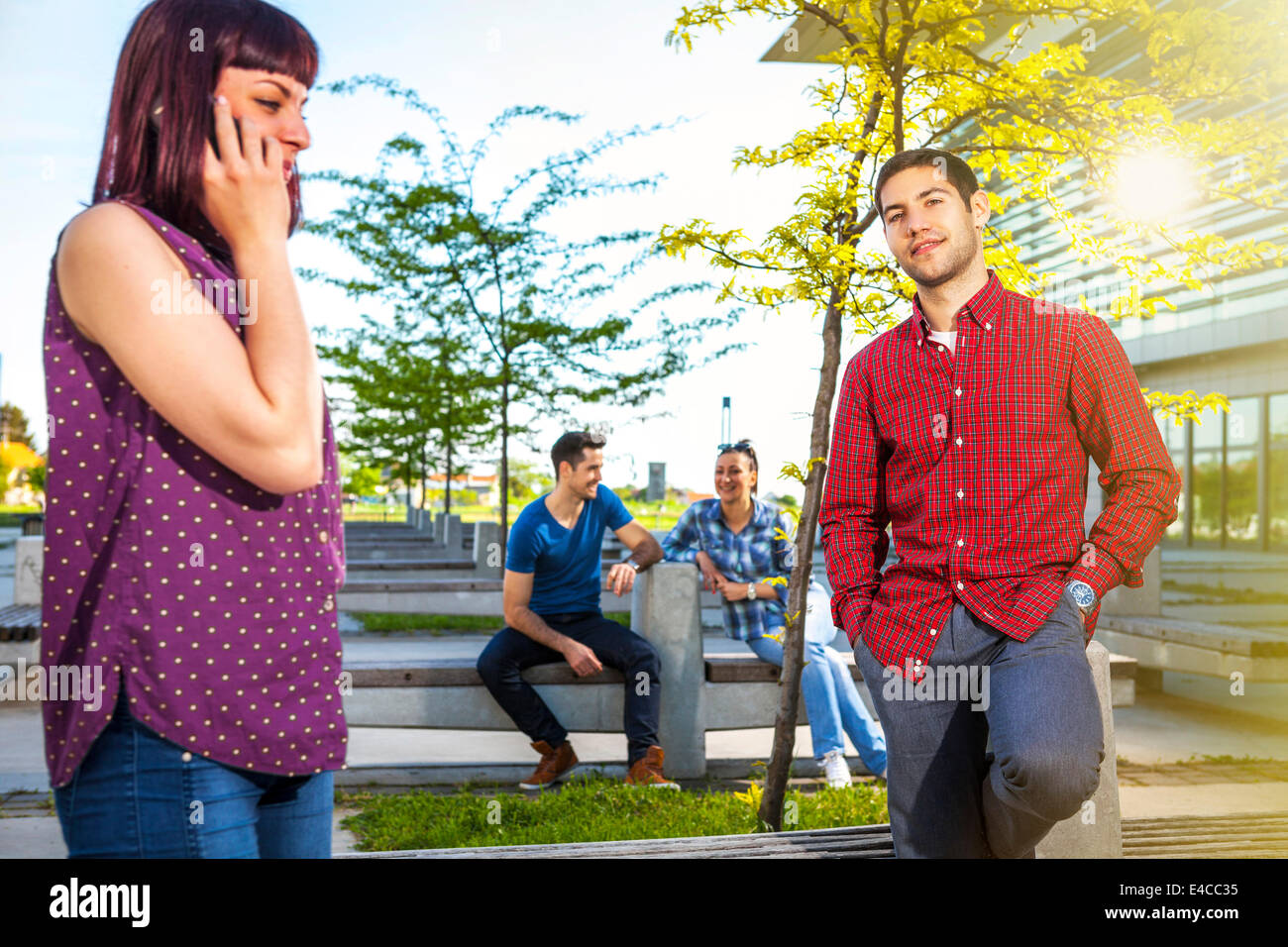 Young couple outdoors people in background Stock Photo - Alamy