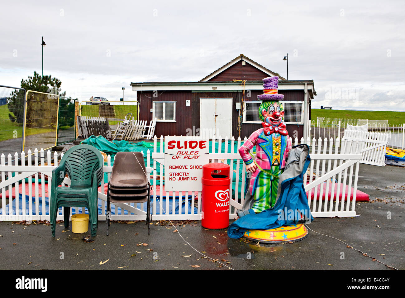 Life size clown statue draped in a tarpaulin in front of children's ...