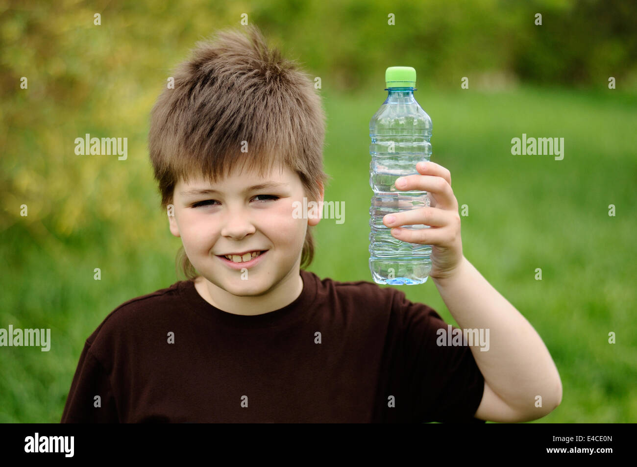 A boy with a bottle of water in nature Stock Photo - Alamy