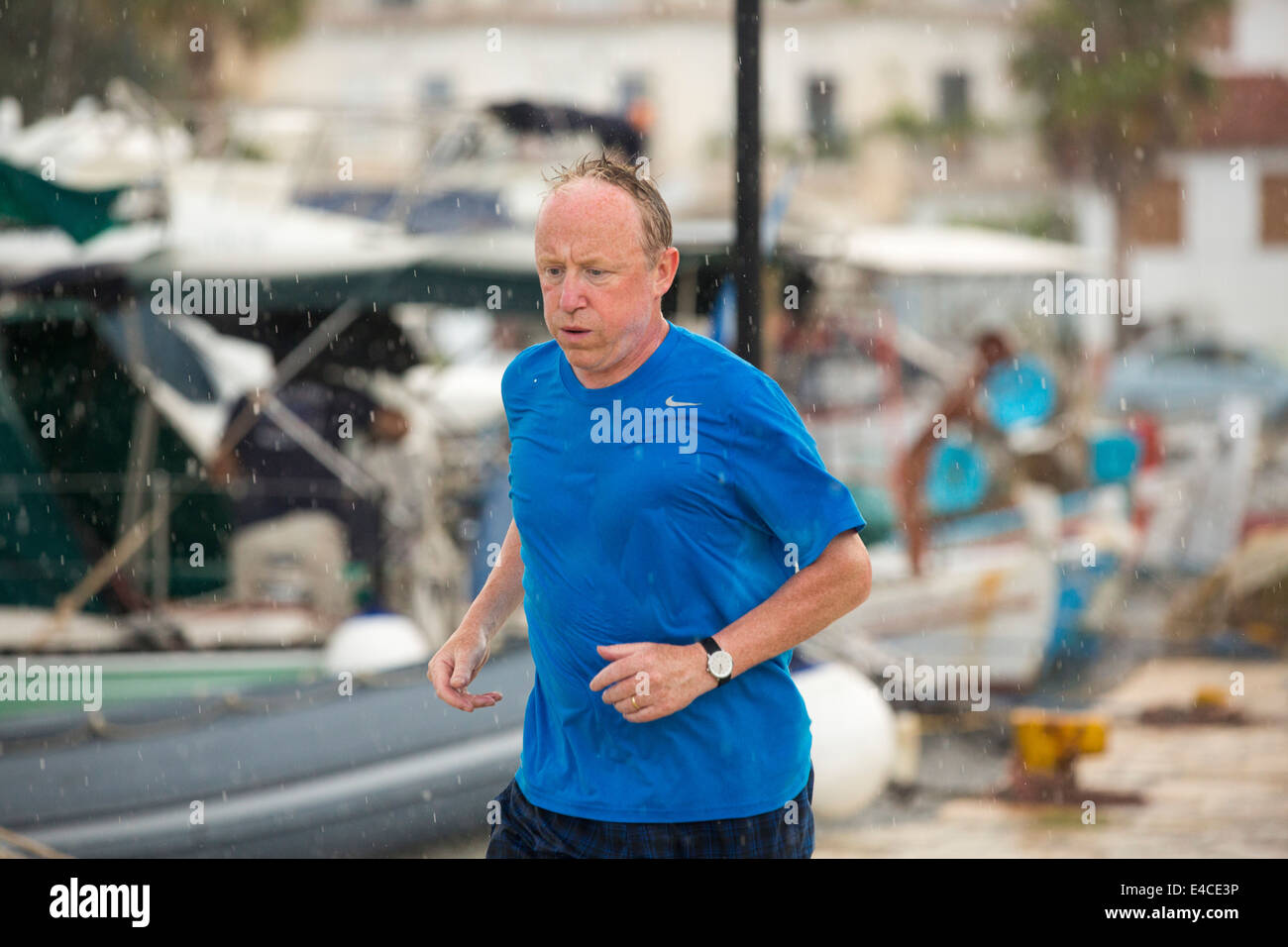 Man running in rain hi-res stock photography and images - Alamy