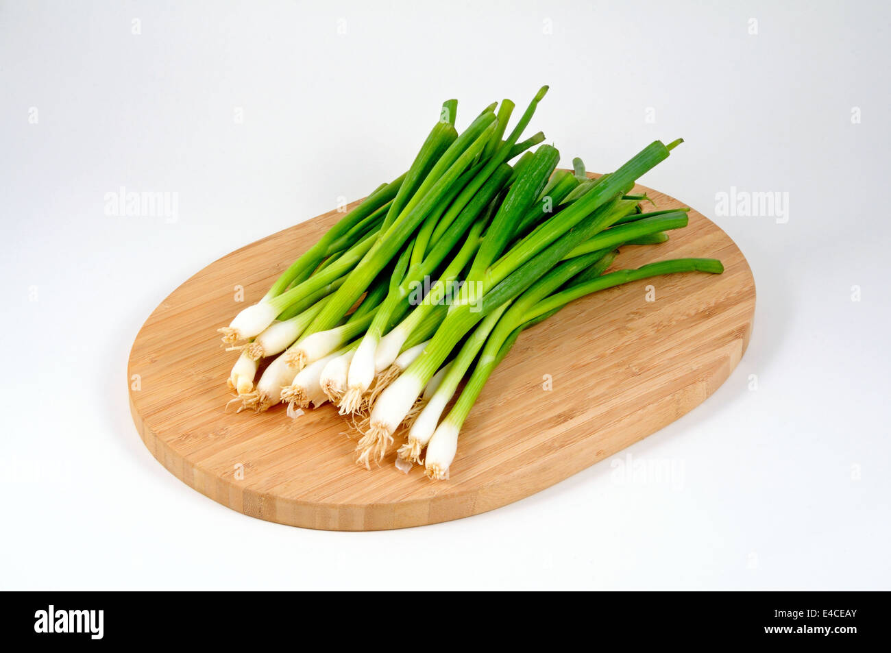 Bunch of white spring onions on a wooden chopping board Stock Photo - Alamy