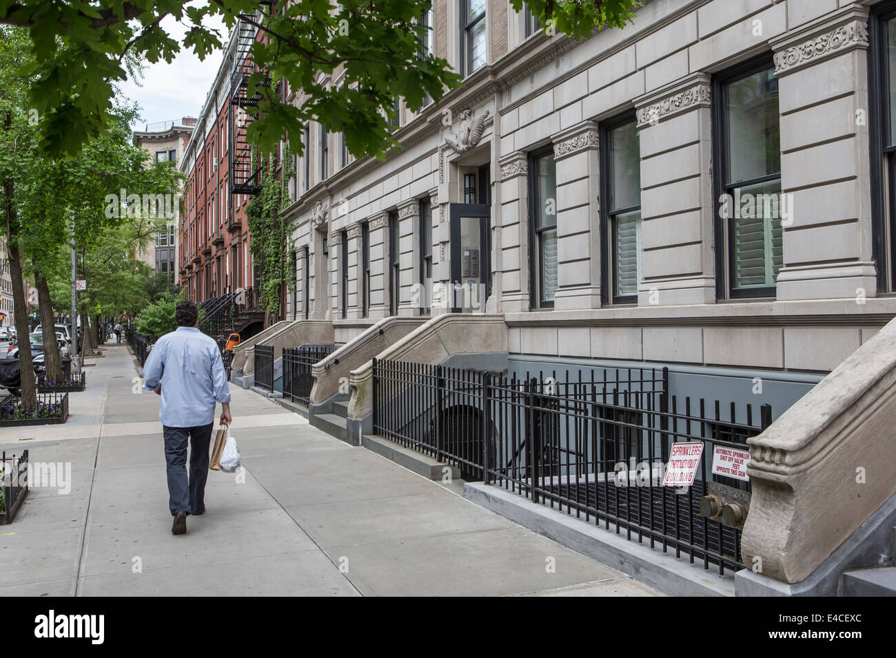 A man walks in the Chelsea neighborhood of the New York City borough of ...
