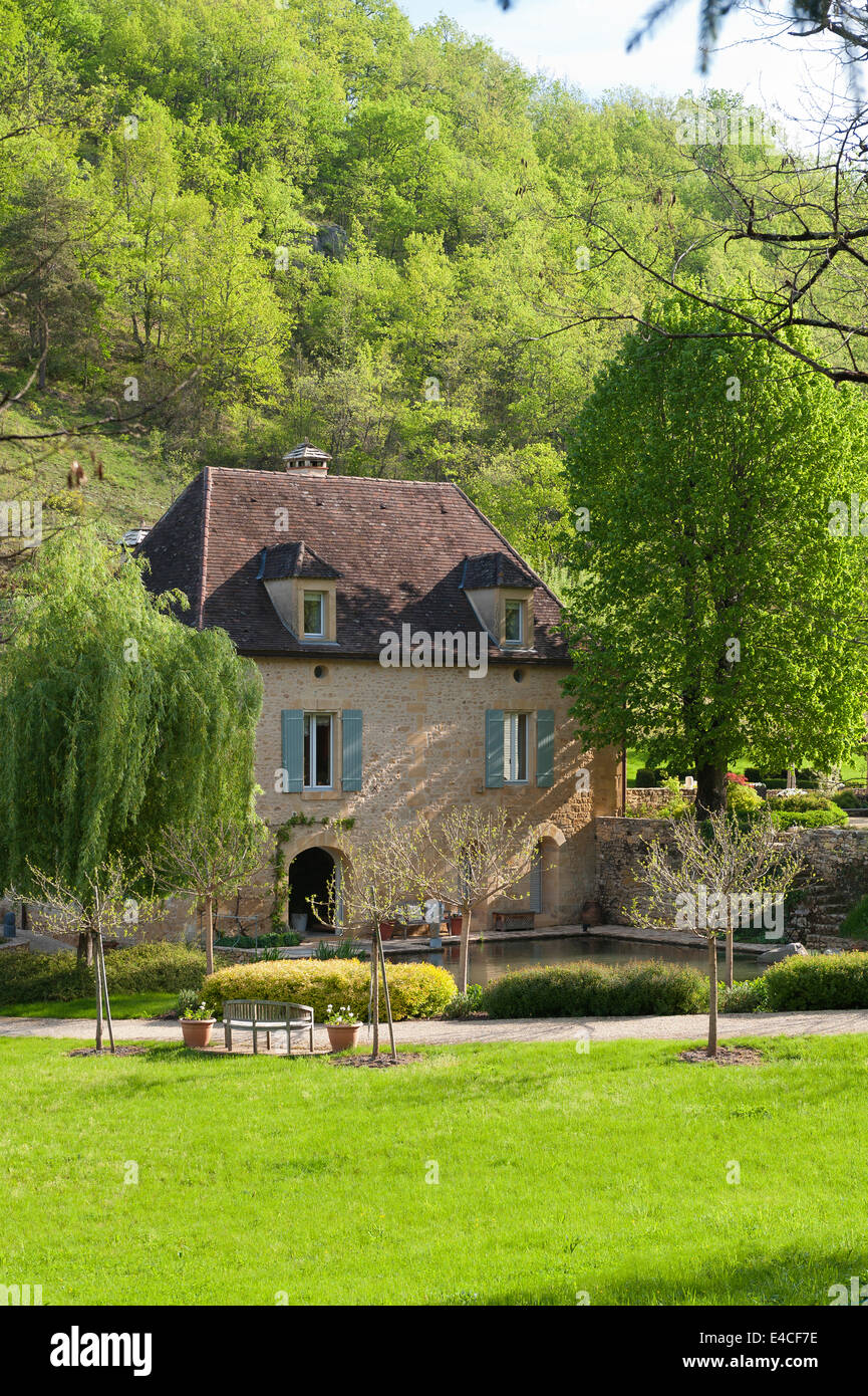 Exterior facade of a 17th century french mill framed by a backdrop of ...