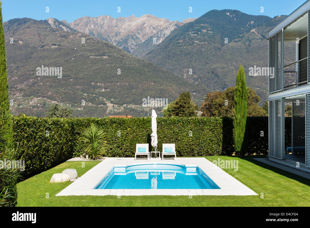 Modern villa with pool, view from the garden Stock Photo - Alamy