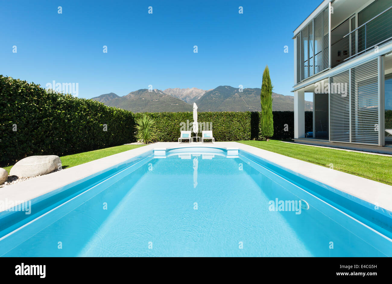 Modern villa with pool, view from the garden Stock Photo - Alamy