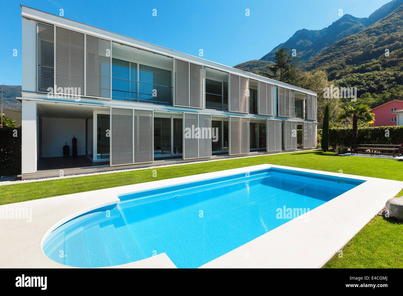Modern villa with pool, view from the garden Stock Photo - Alamy