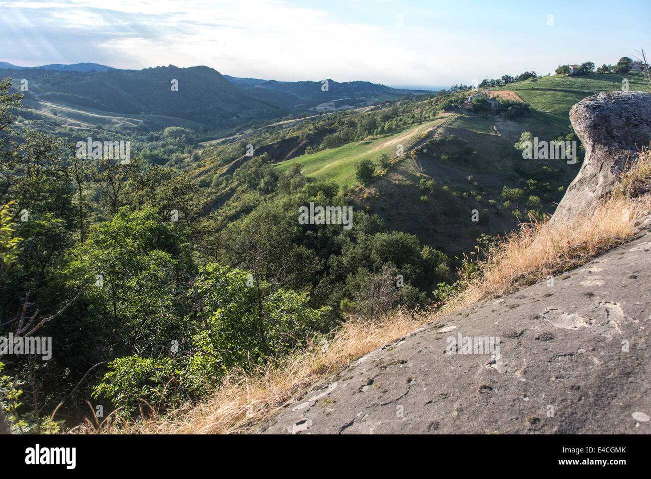 green countryside valley with sunrays and path Stock Photo - Alamy