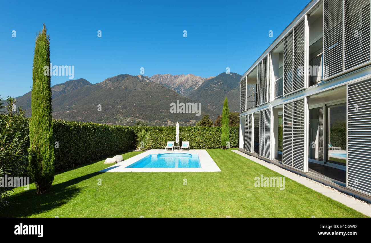 Modern villa with pool, view from the garden Stock Photo - Alamy
