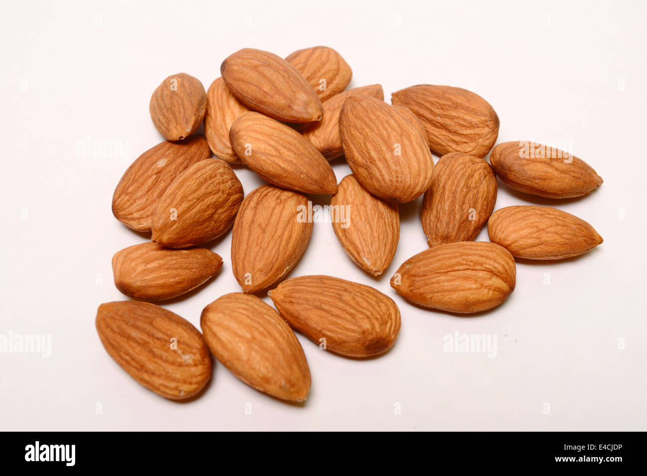 Unshelled almonds on a white background Stock Photo - Alamy