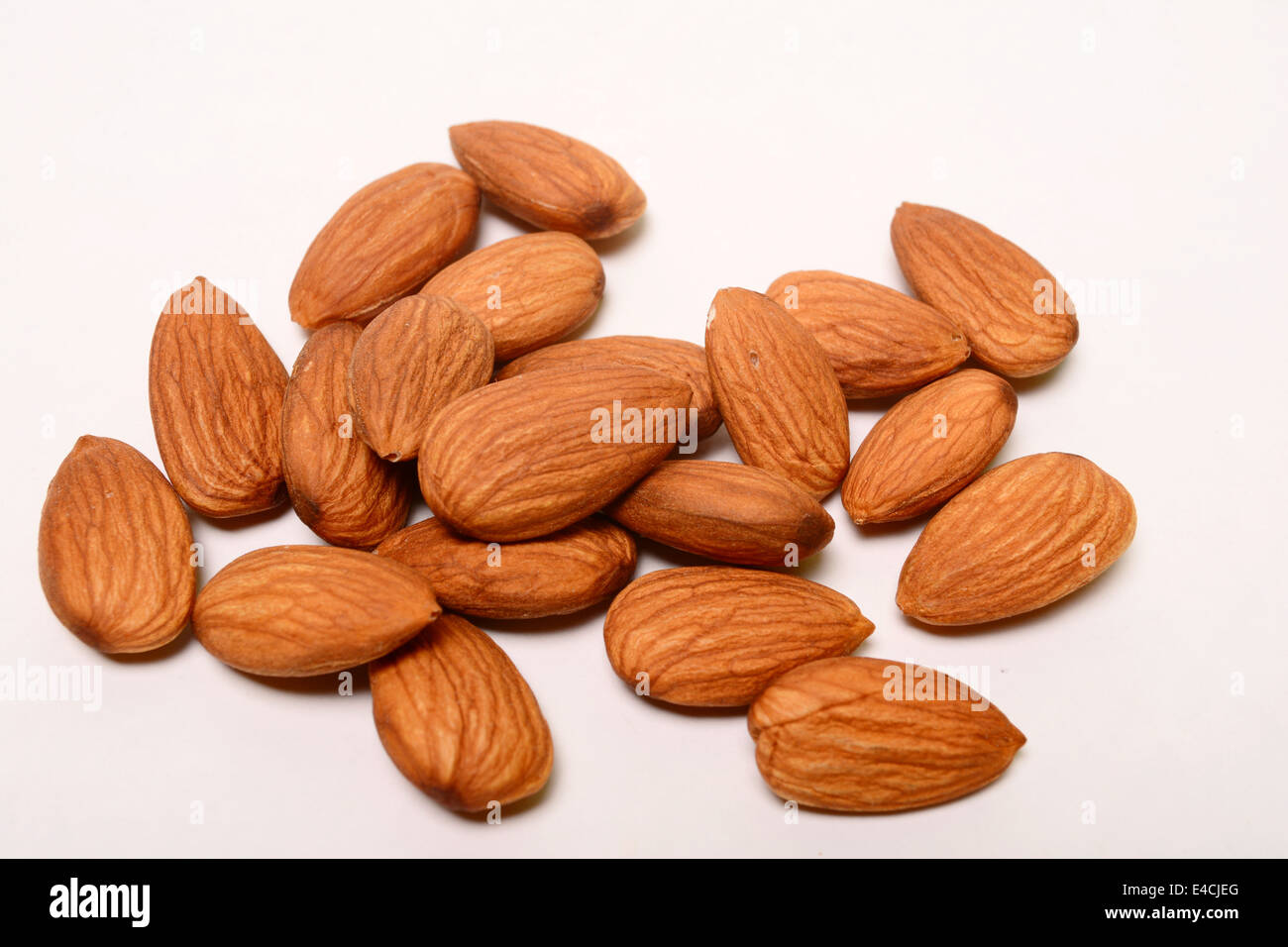 Unshelled almonds on a white background Stock Photo - Alamy