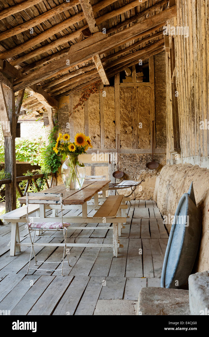 Wooden picnic table with bench under wooden lean to Stock Photo - Alamy