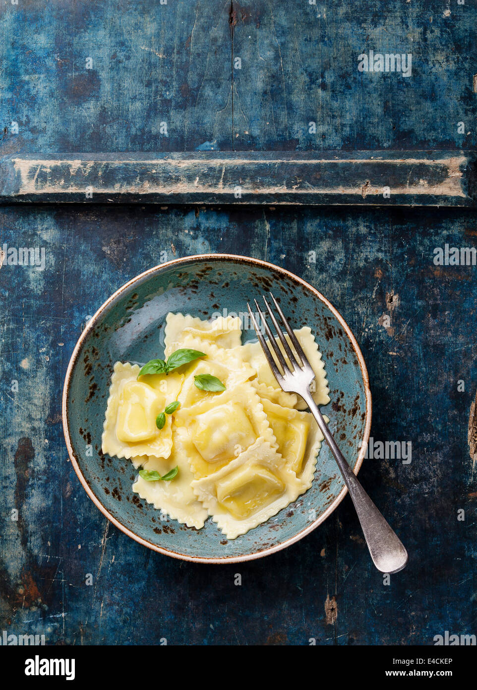 Ravioli pasta with mozzarella cheese and basil on blue background Stock ...