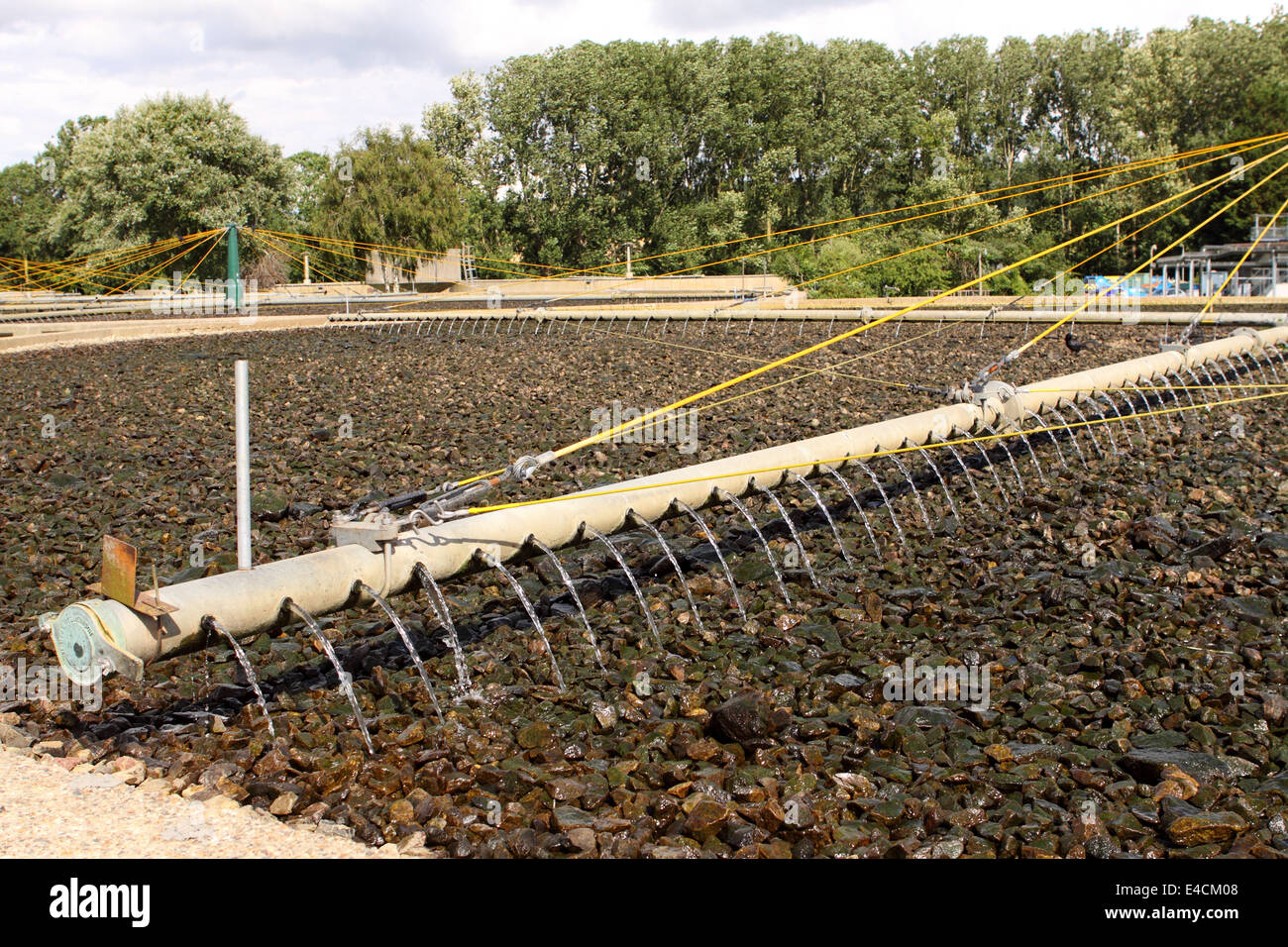 Sewage treatment plant works the rotating arm pours sewage over the ...