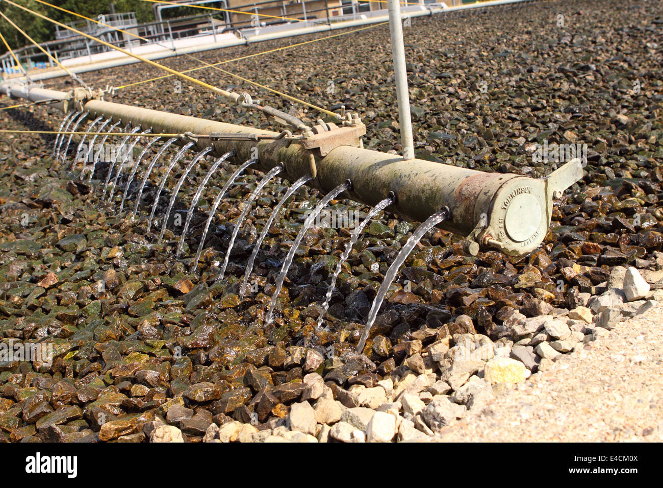 Sewage treatment plant works the rotating arm pours sewage over the ...