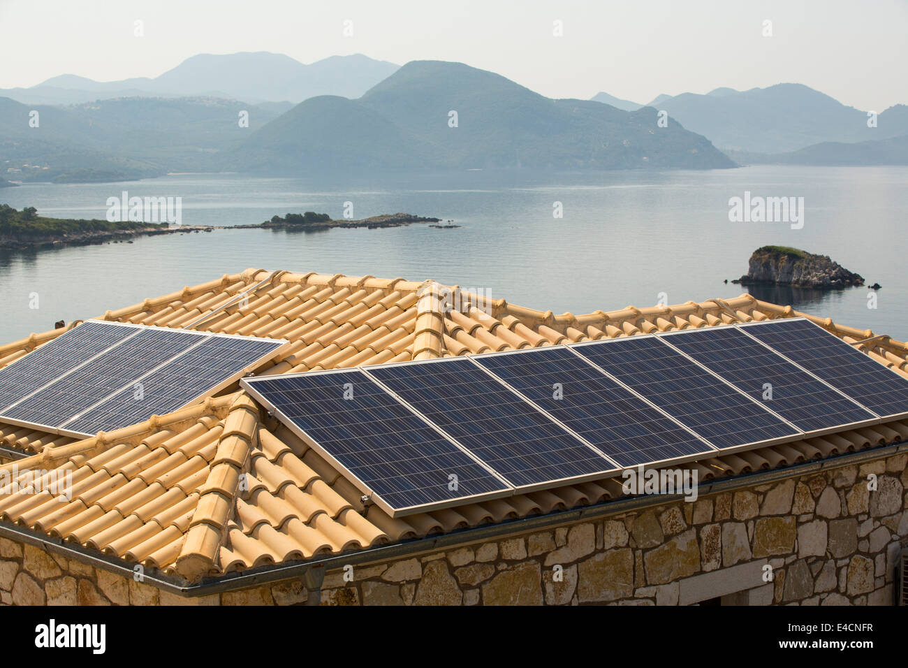 Solar panels on a house roof in Sivota, Greece Stock Photo - Alamy