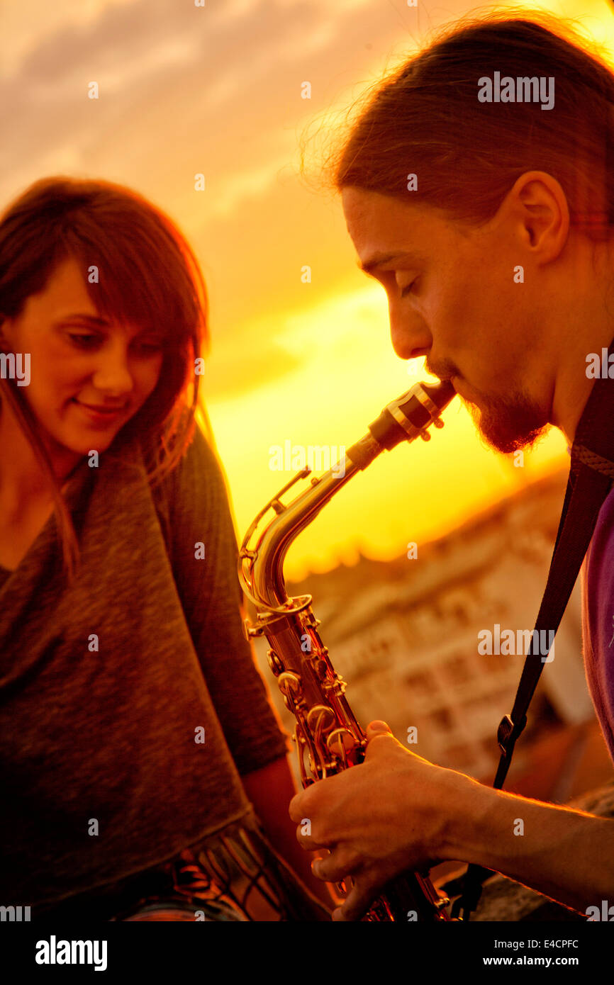 Young man playing the saxophone at sunset, Osijek, Croatia Stock Photo ...