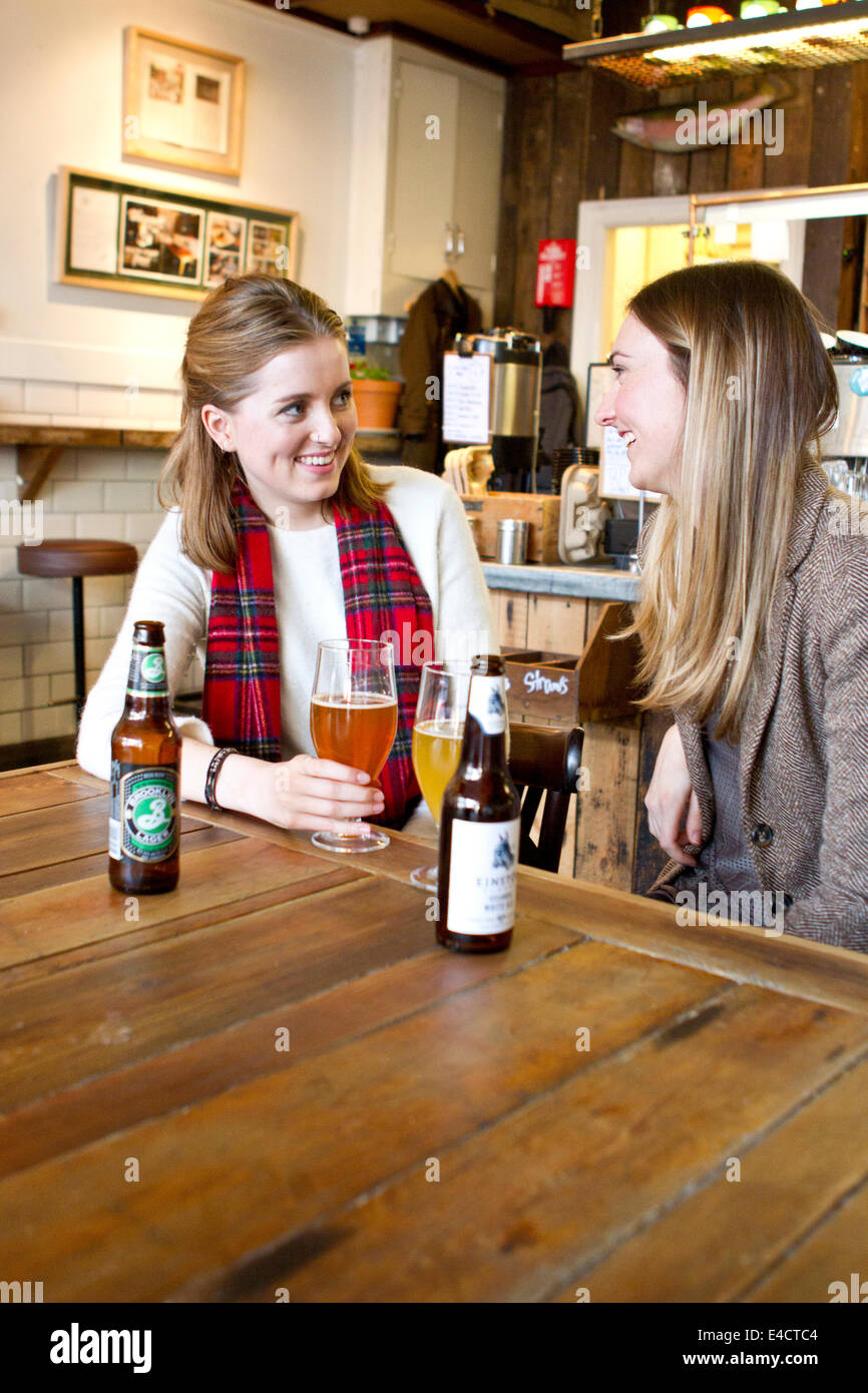 Young women drinking beer in pub, Dorset, Bournemouth, England Stock ...