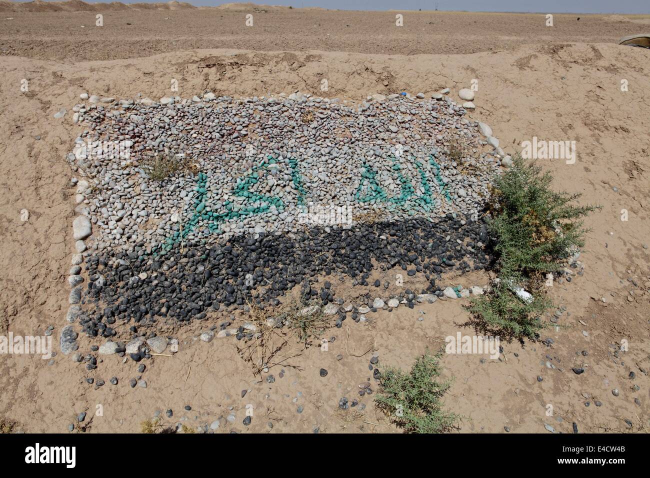Kirkuk, Iraq. 7th July, 2014. A faded mural of an Iraqi flag was made ...