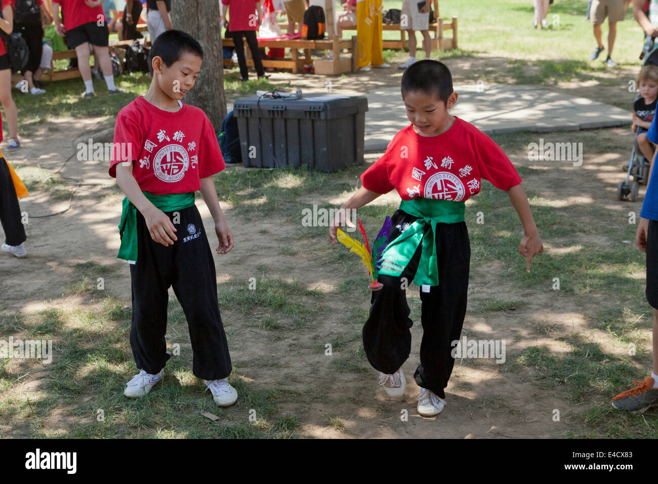 Kids playing jianzi (Chinese shuttlecock) at a cultural festival ...