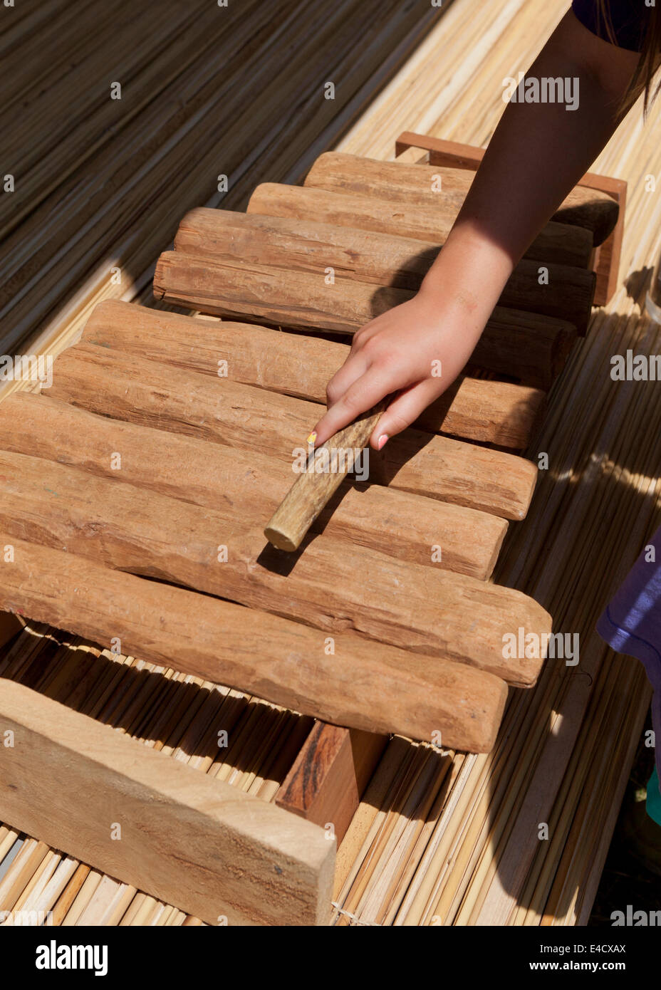 Woman playing handmade balafon (wooden xylophone) from Kenya - USA ...