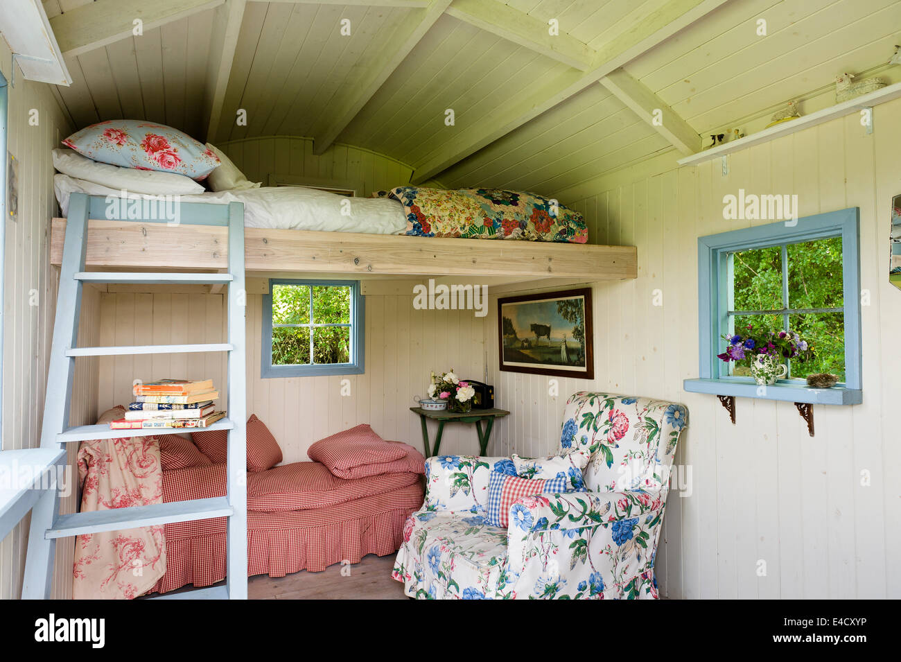 Quaint interior of a wooden shepherds hut with floral patterned ...