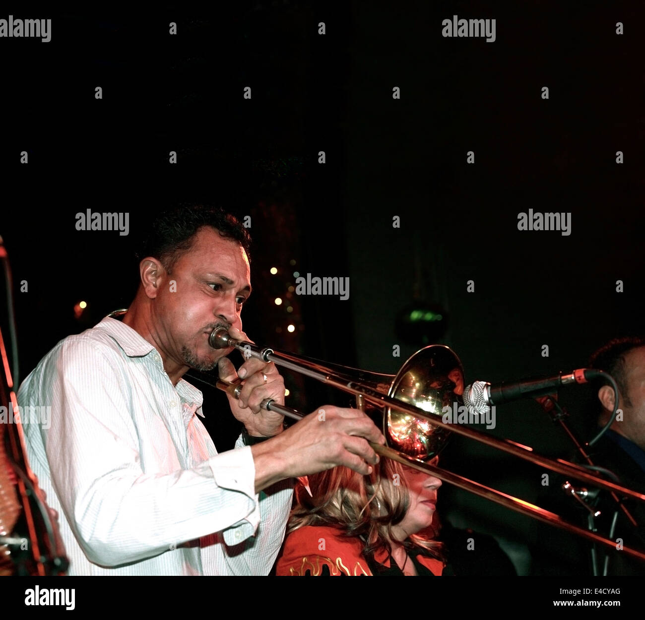 Musician playing trombone live in night club. He is Puerto Rican Stock ...