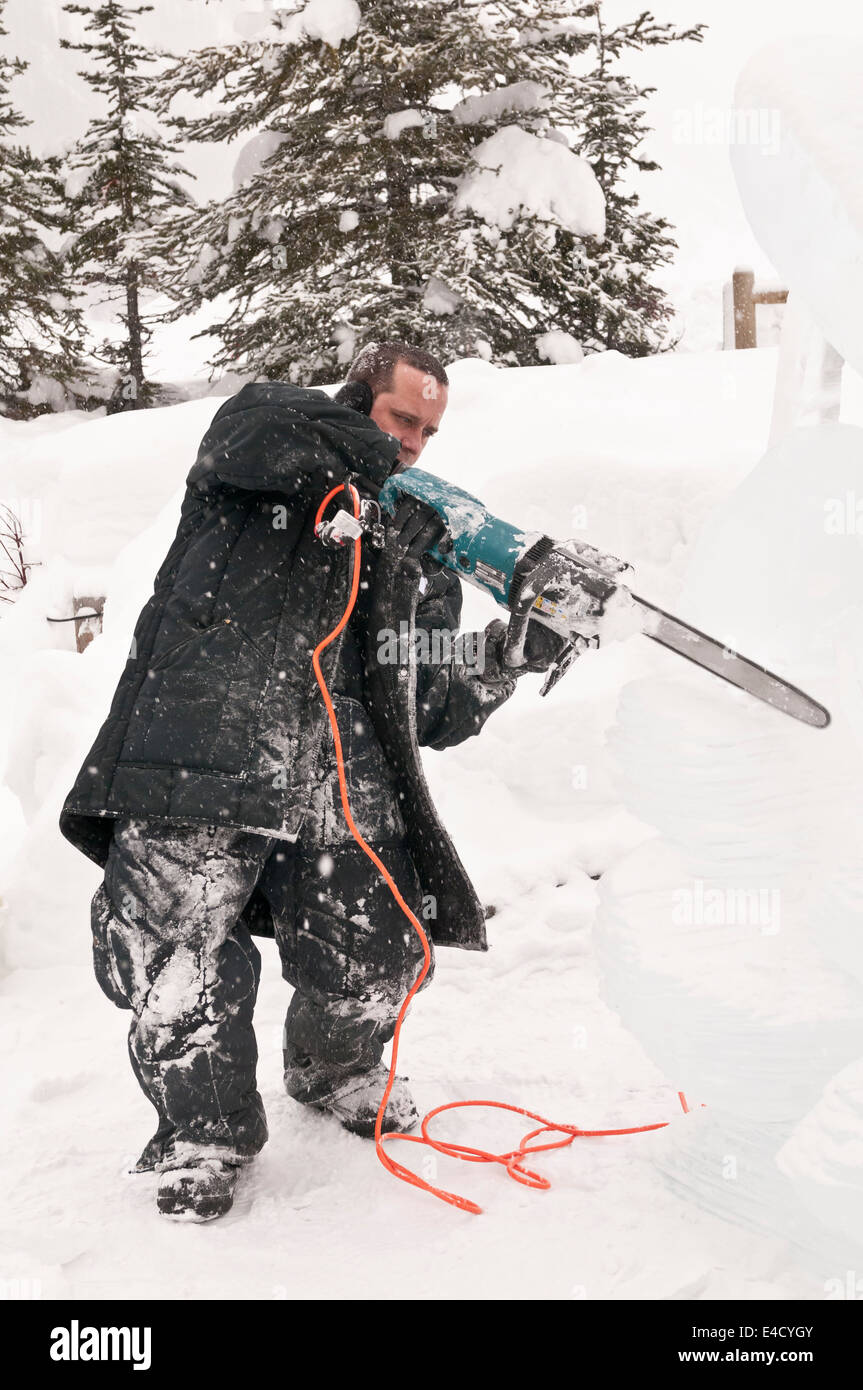 Ice carver at the Lake Louise Ice Sculpting Festival, Lake Louise ...