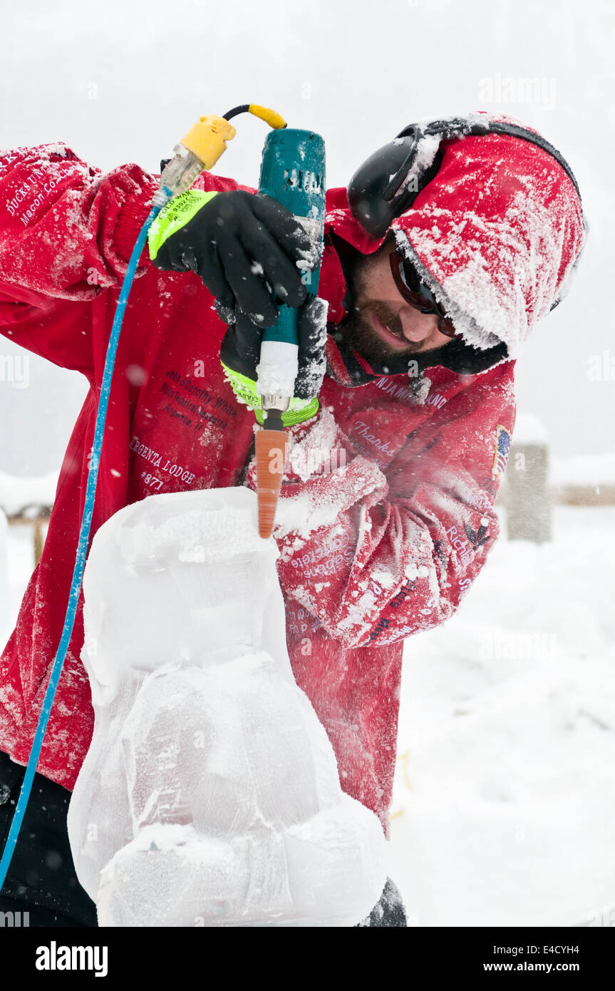 Ice carver at the Lake Louise Ice Sculpting Festival, Lake Louise ...