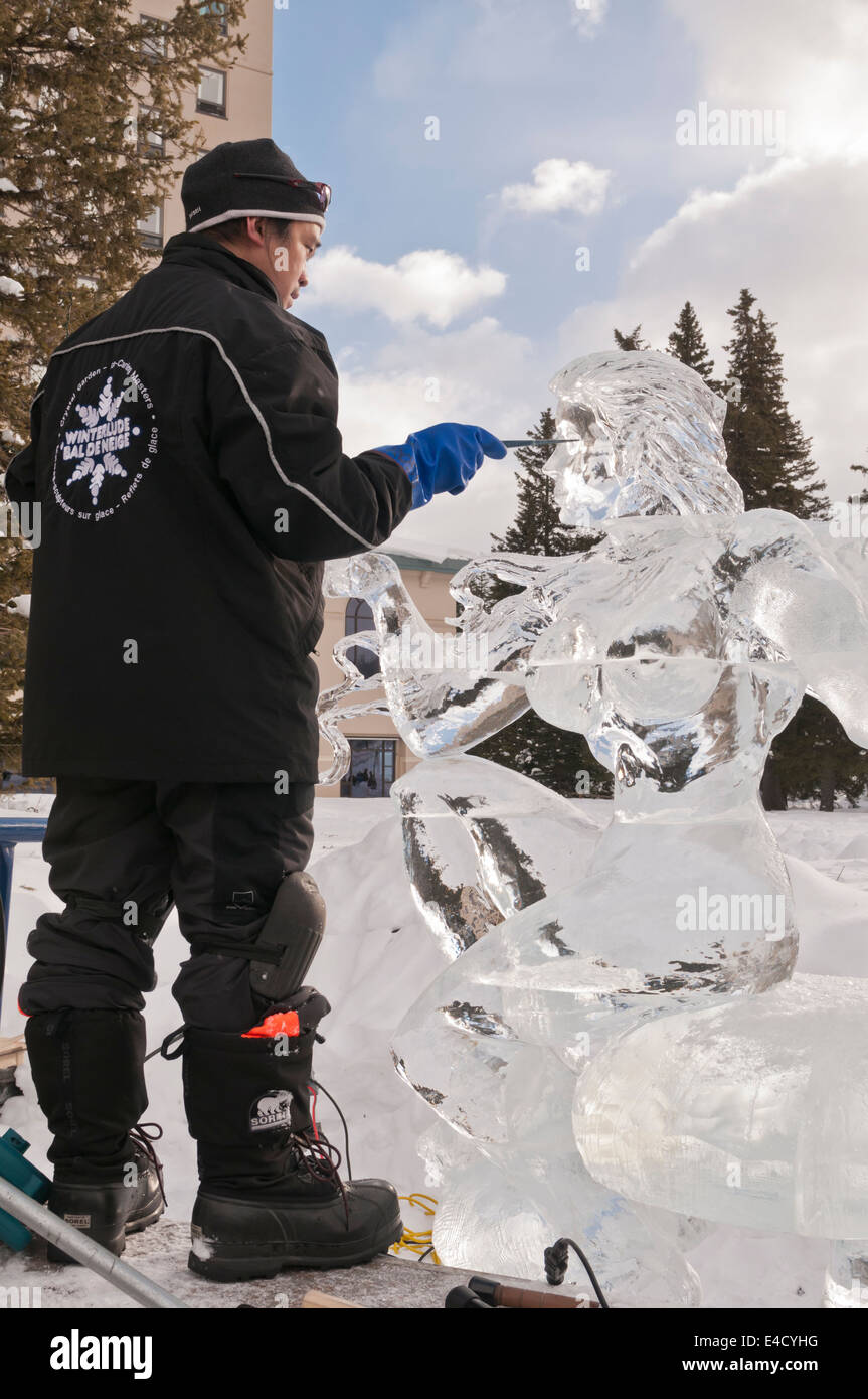 Ice carver at the Lake Louise Ice Sculpting Festival, Lake Louise ...