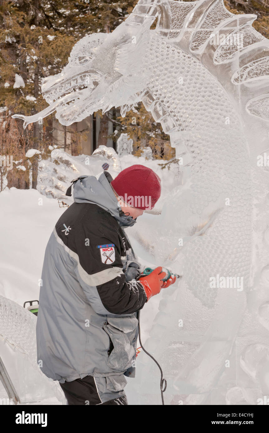 Ice carver at the Lake Louise Ice Sculpting Festival, Lake Louise ...