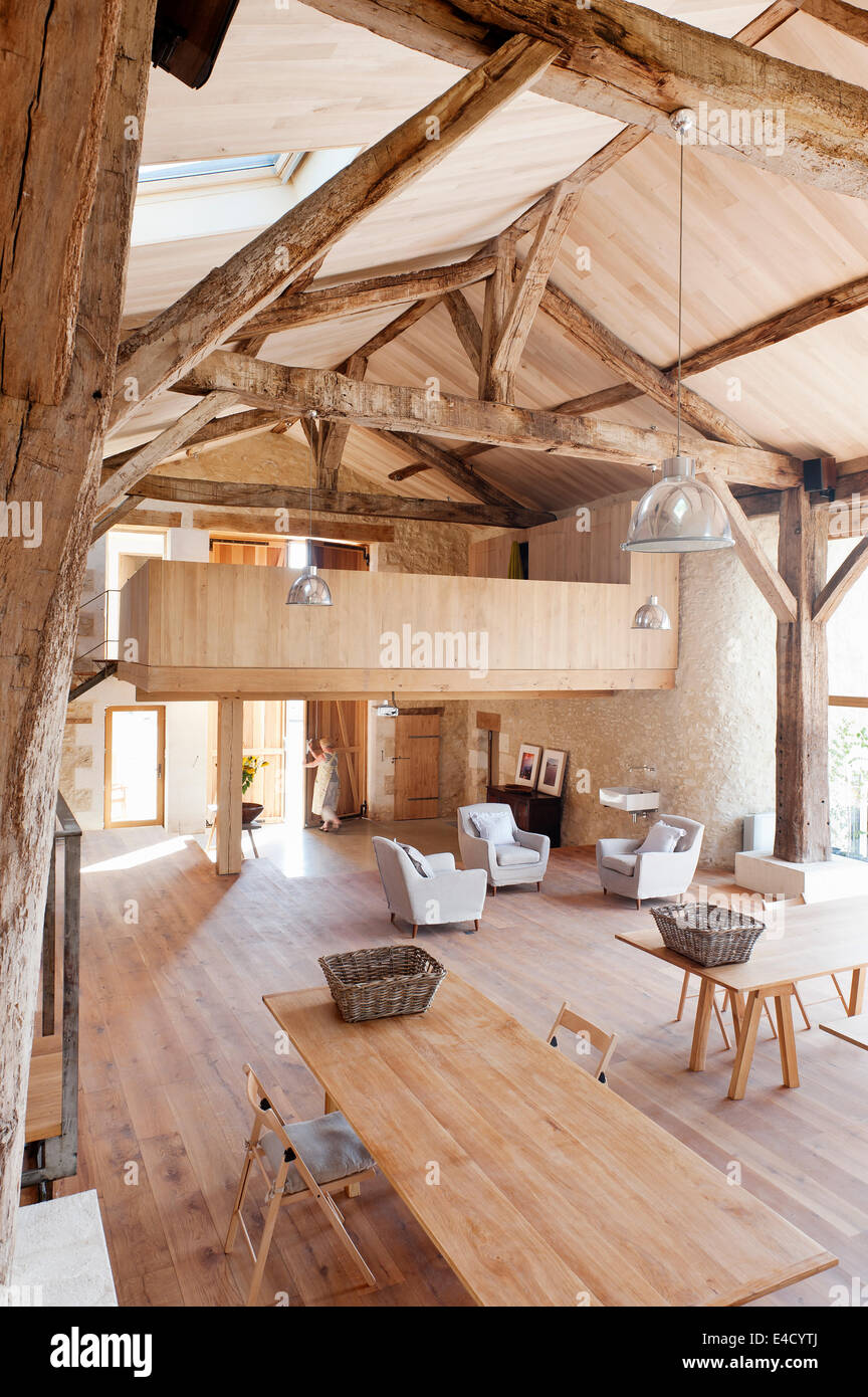 Converted barn with original timber beams, wooden work tables and ...