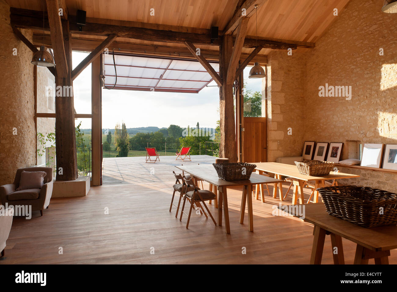Converted barn with original timber beams, wooden work tables and large ...