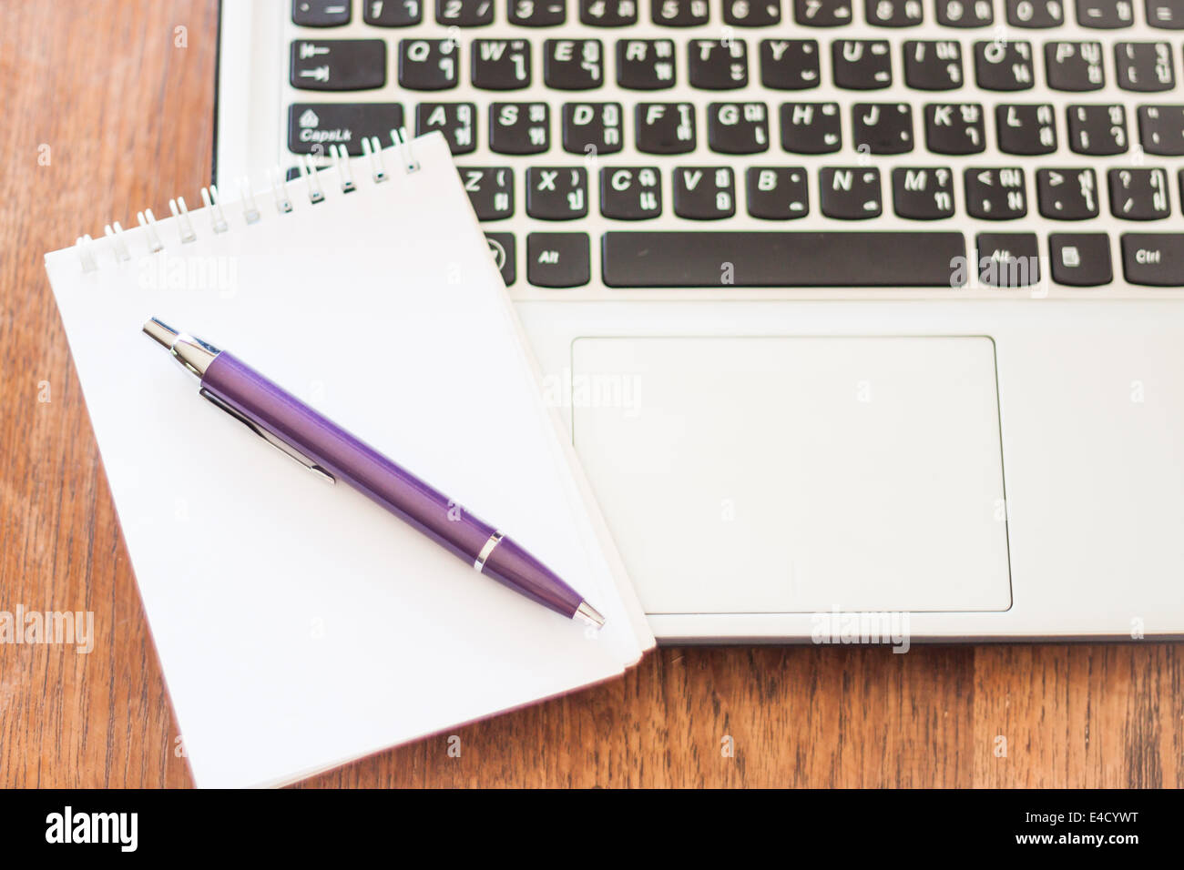 Notepad and laptop on wooden table, stock photo Stock Photo - Alamy