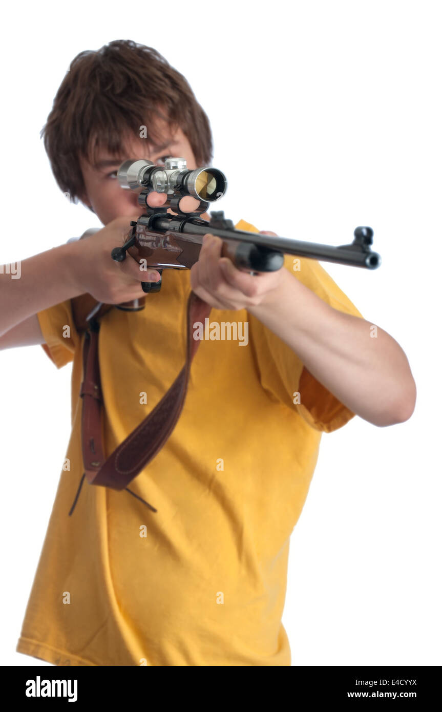 Teenage boy with a high powered hunting rifle. Isolated against a white ...