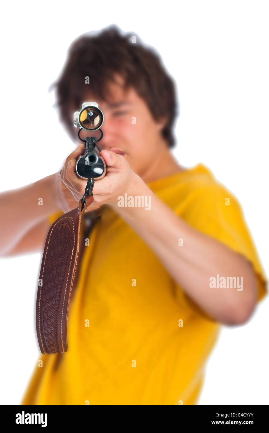 Teenage boy with a high powered hunting rifle. Isolated against a white ...