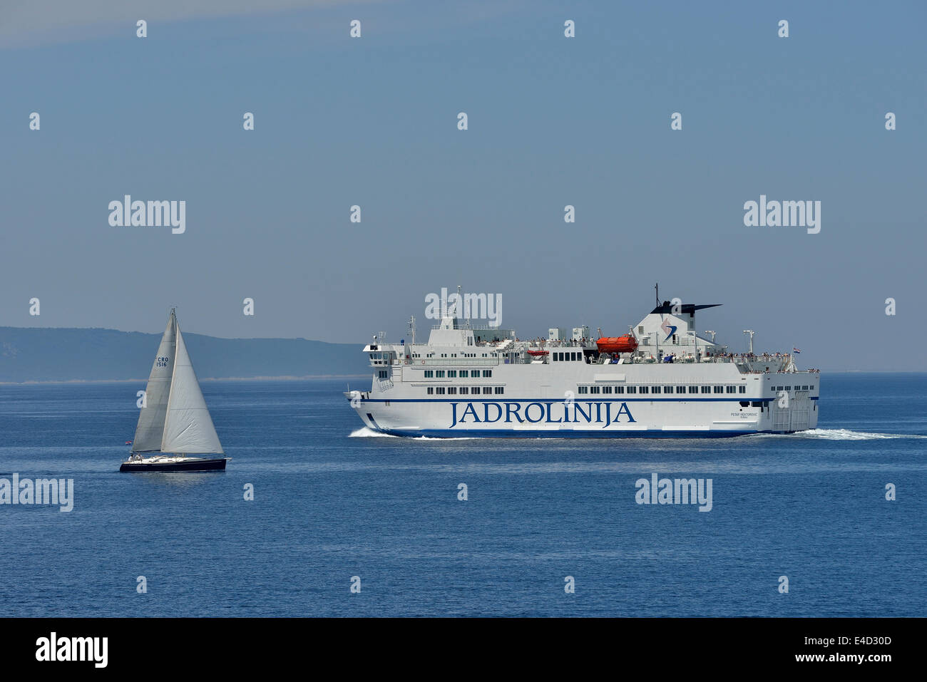 Sailing boat and ferry of the Jadrolinija shipping company, near Split ...