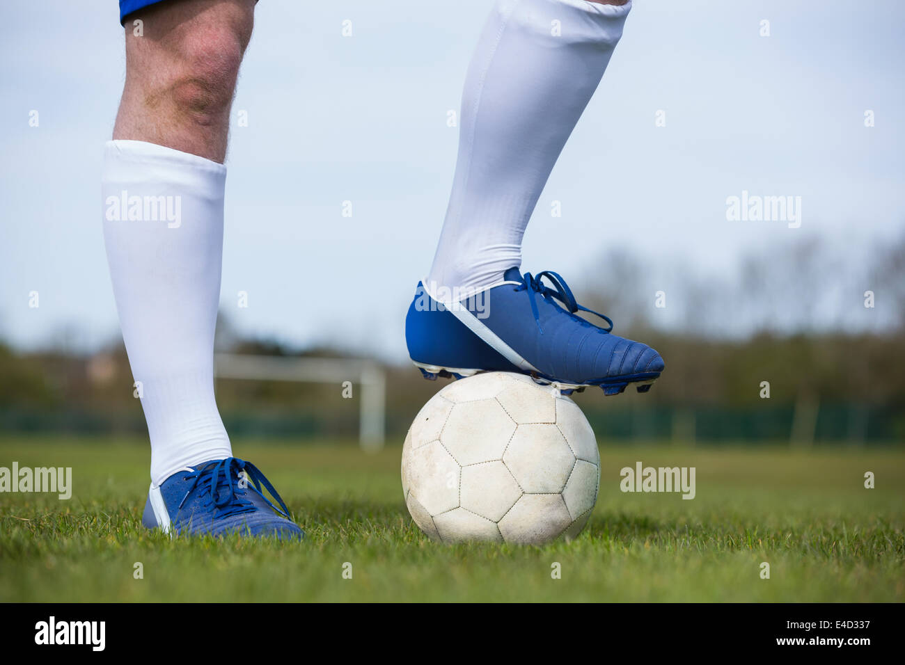 Football player standing with the ball Stock Photo - Alamy