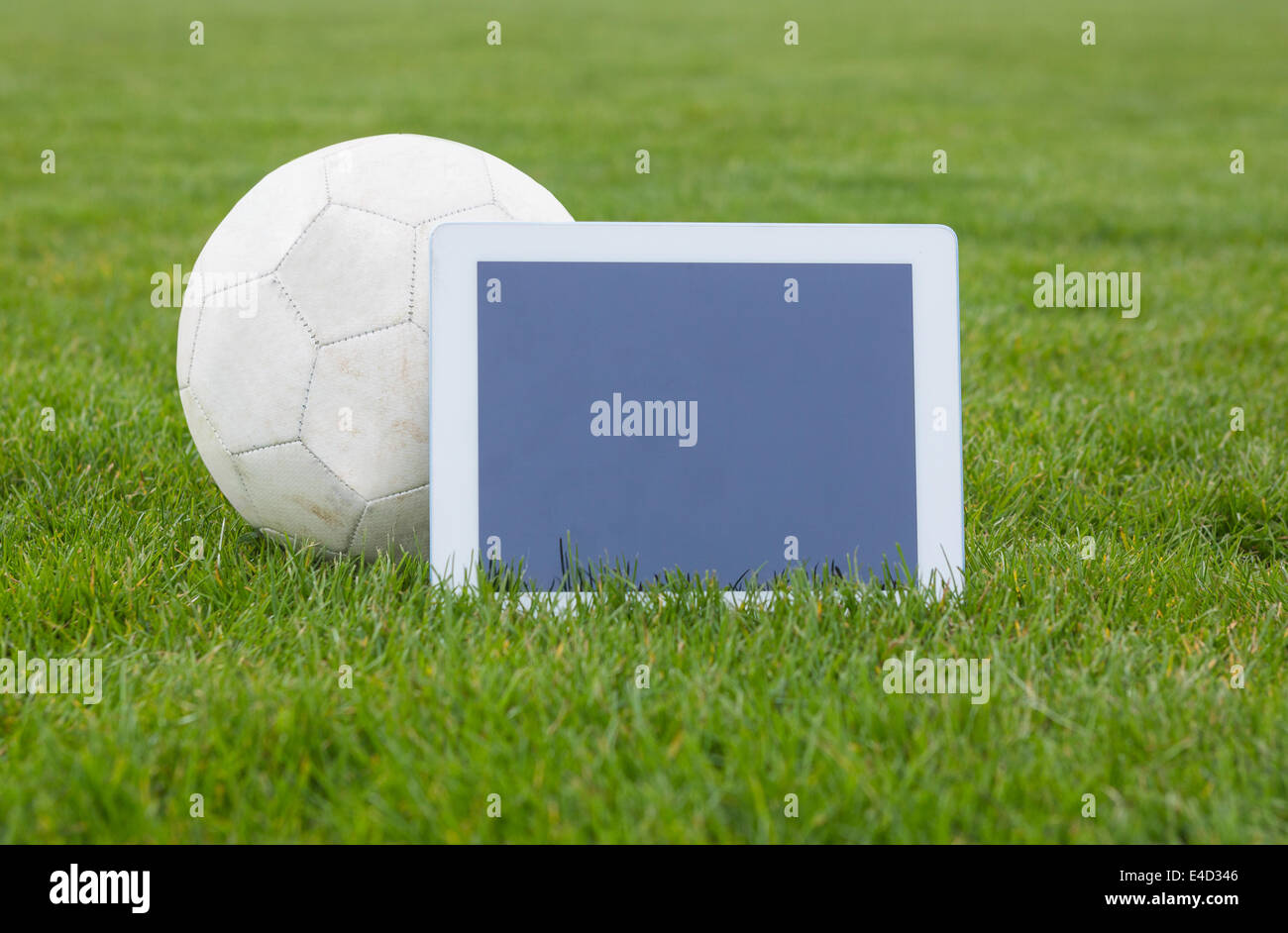 Football and tablet with blank screen on pitch Stock Photo - Alamy
