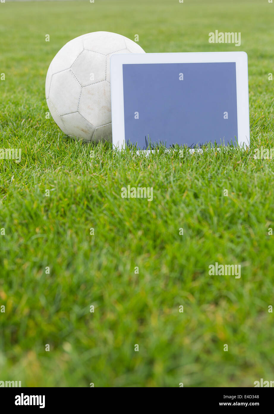 Football and tablet with blank screen on pitch Stock Photo - Alamy