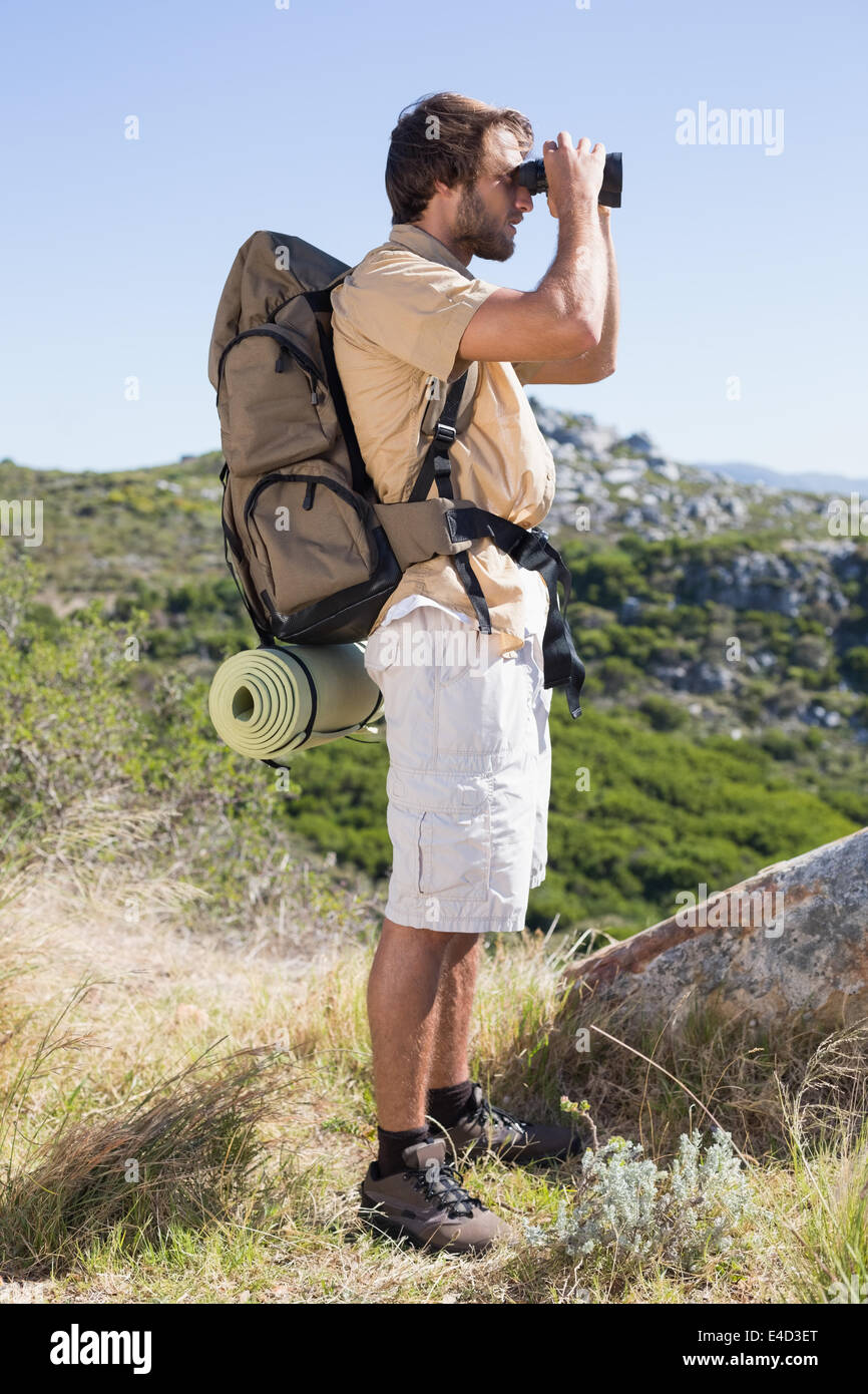 Handsome hiker looking through binoculars Stock Photo - Alamy