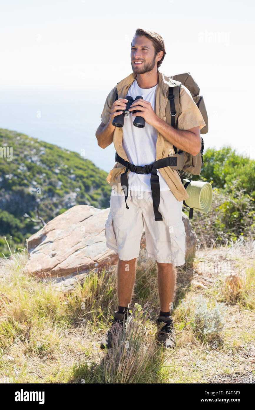 Handsome hiker holding binoculars on mountain trail Stock Photo - Alamy