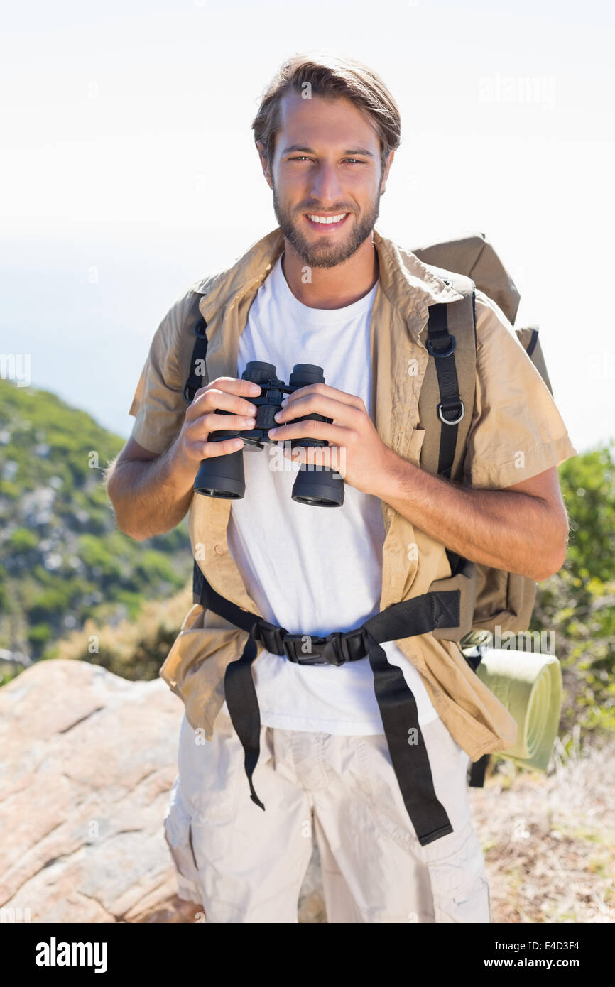 Handsome hiker holding binoculars on mountain trail Stock Photo - Alamy