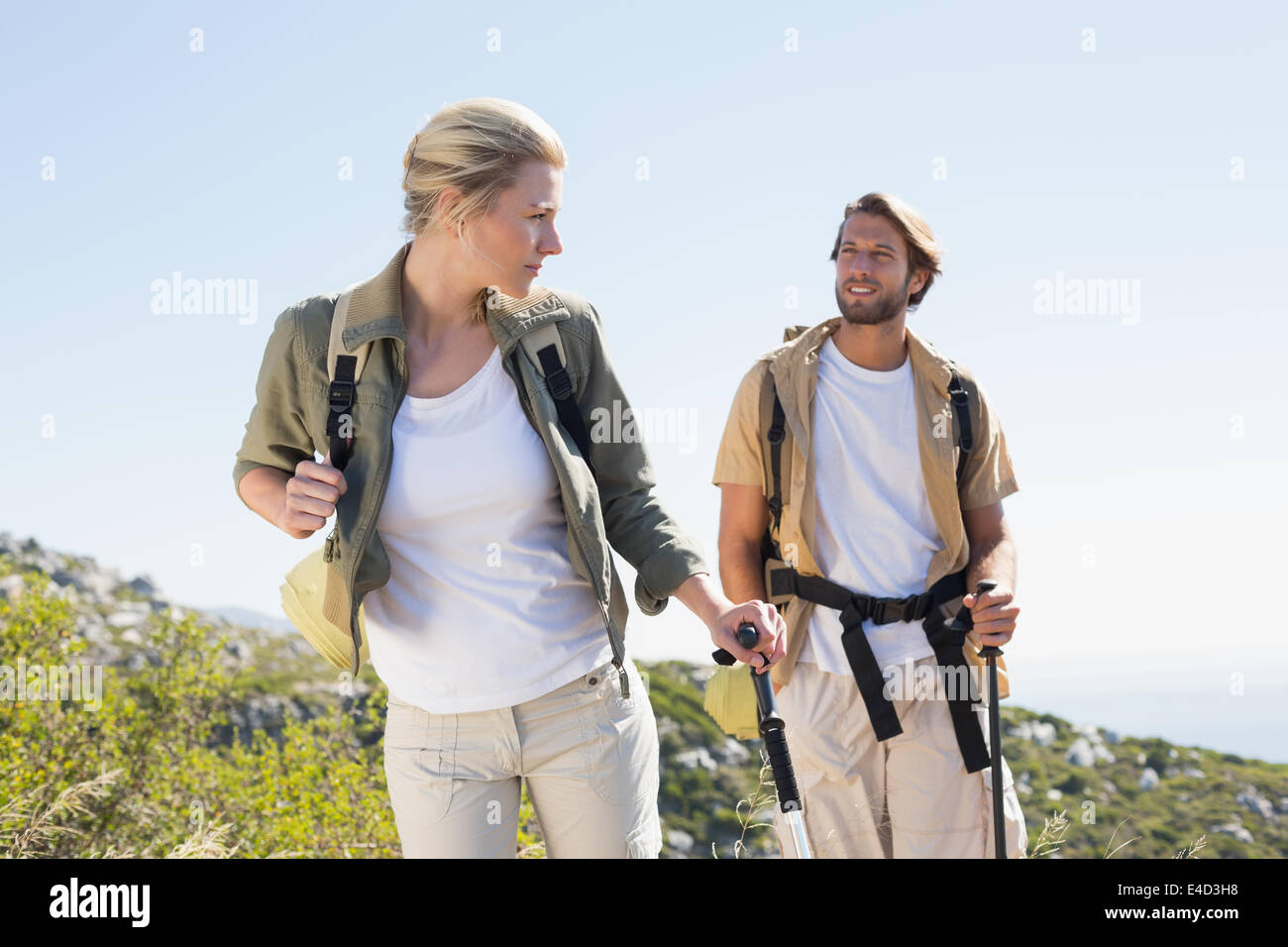 Attractive hiking couple walking on mountain trail Stock Photo - Alamy