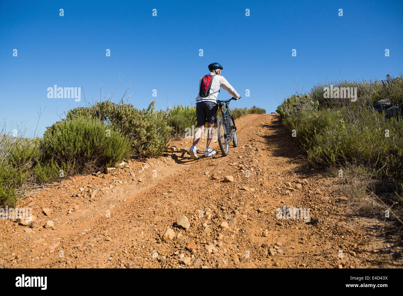 Man pushing his bike hi-res stock photography and images - Alamy